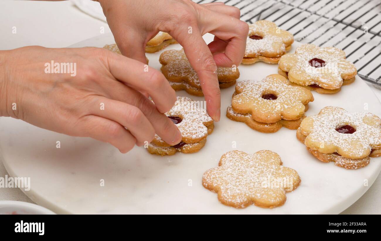 Flower shaped shortbread cookies filled with raspberry jam step by step ...