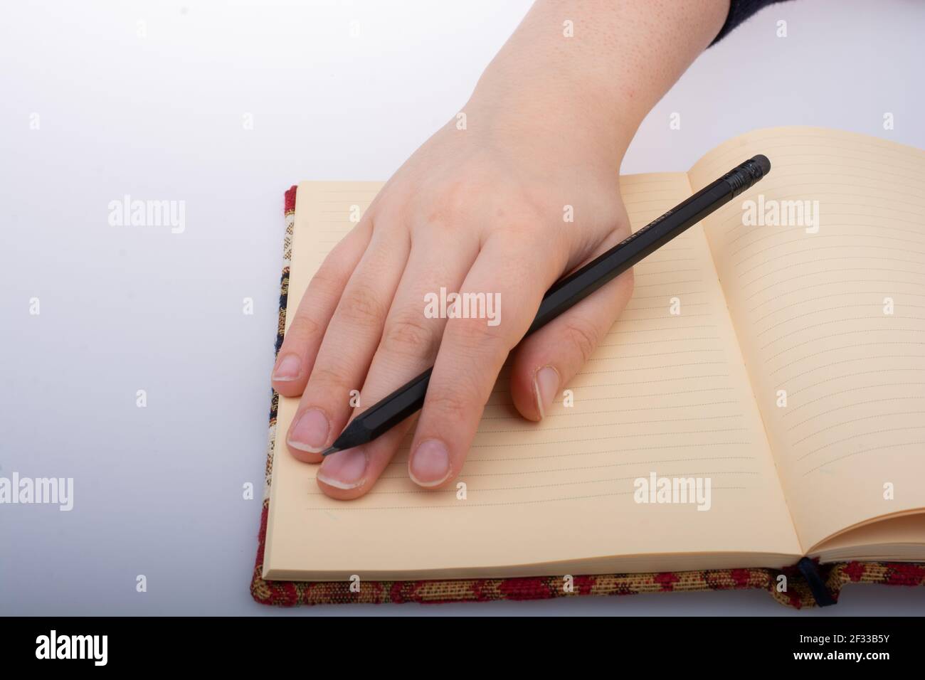 Human hand using pen to write down short note on notebook Stock Photo ...