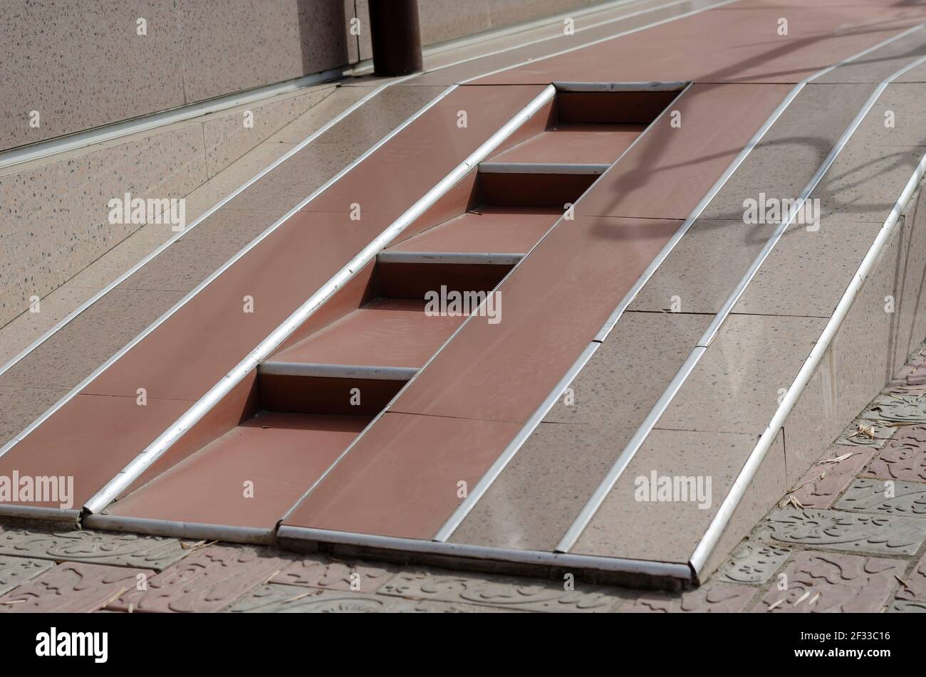 Brown and beige ramp for the disabled with steps. Entrance to the ...
