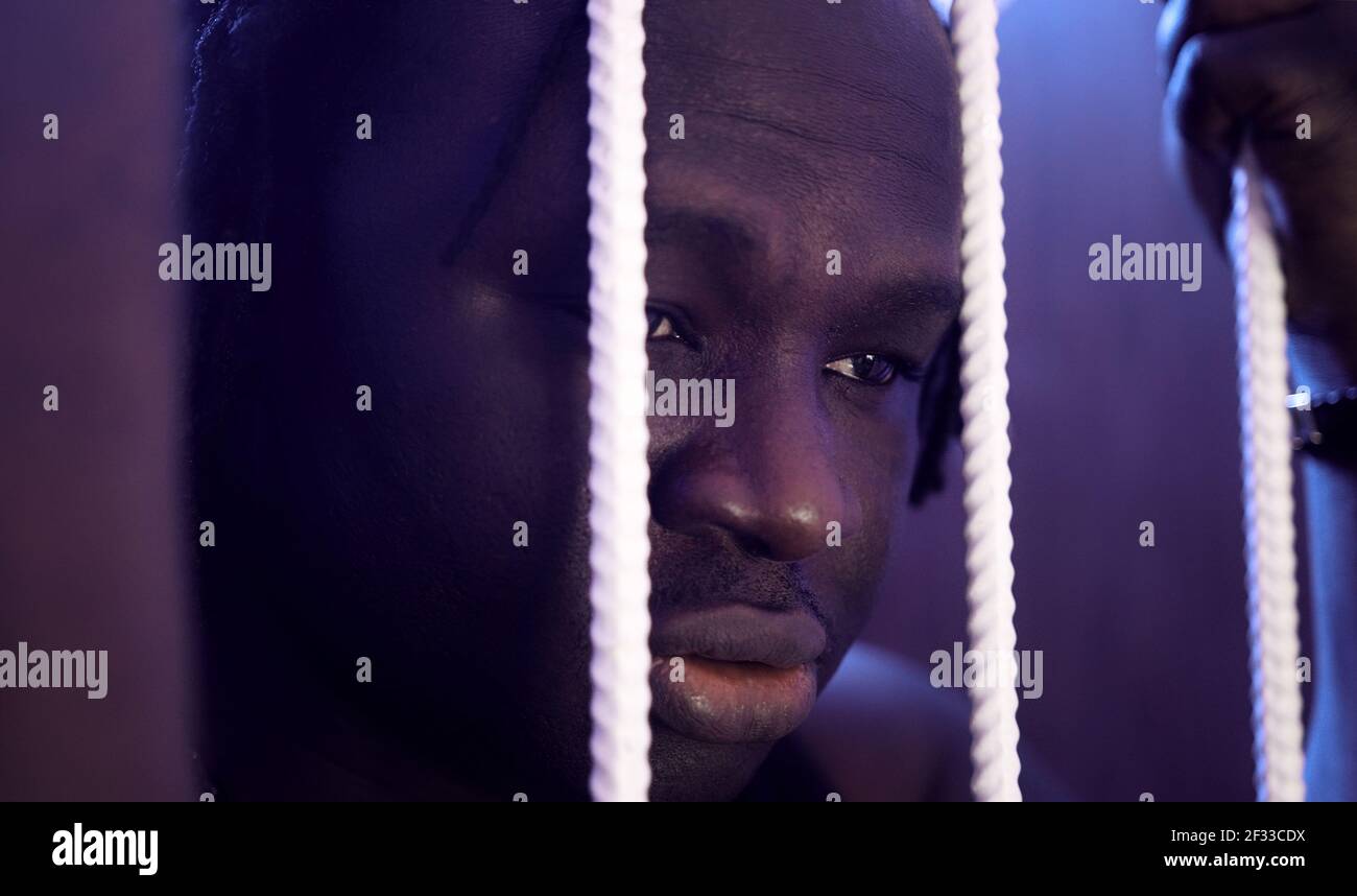 Depresed african american black man holding bars in the prison. High ...
