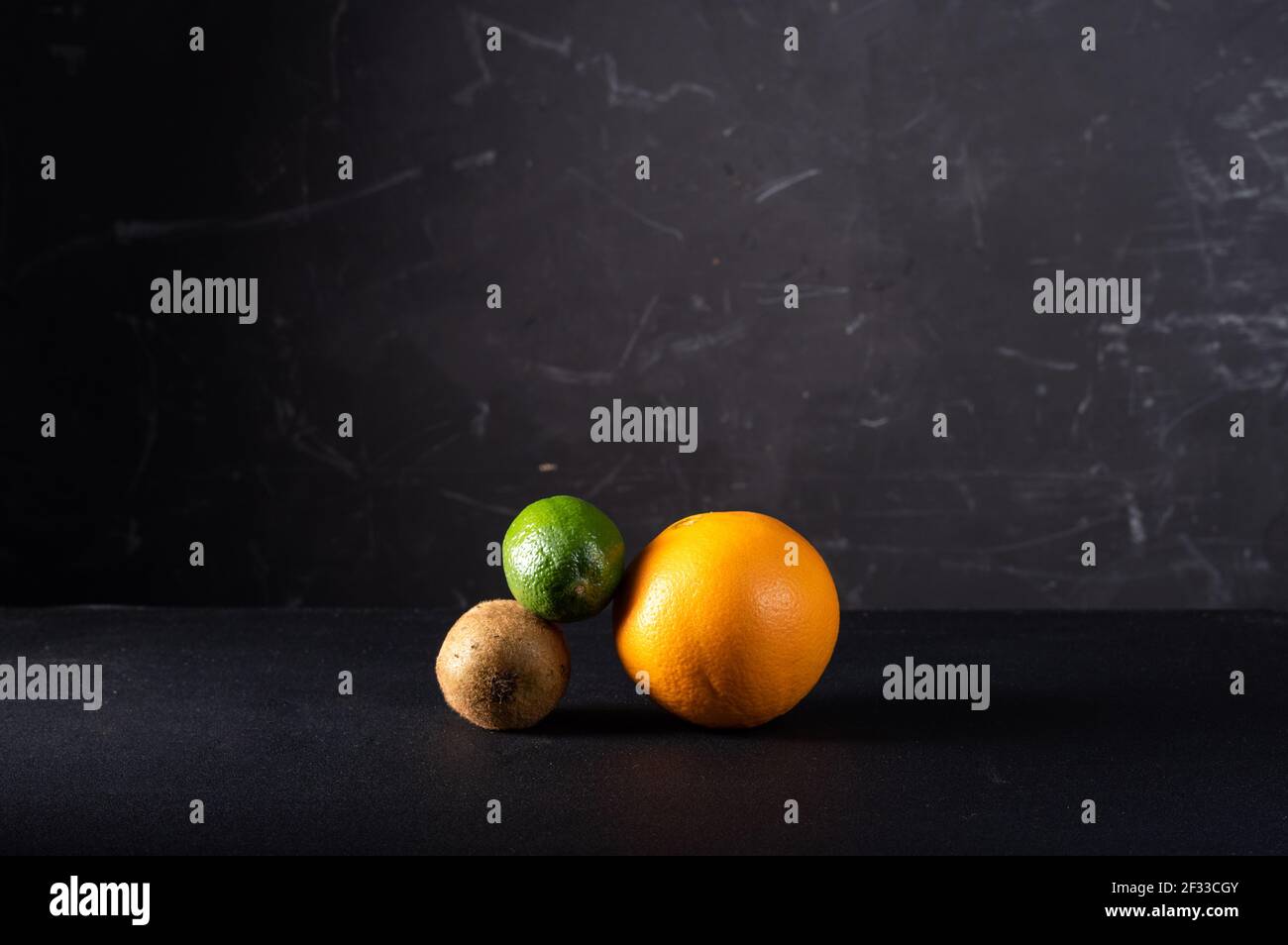 Figure from different fruits on a black background. Multi-colored ...