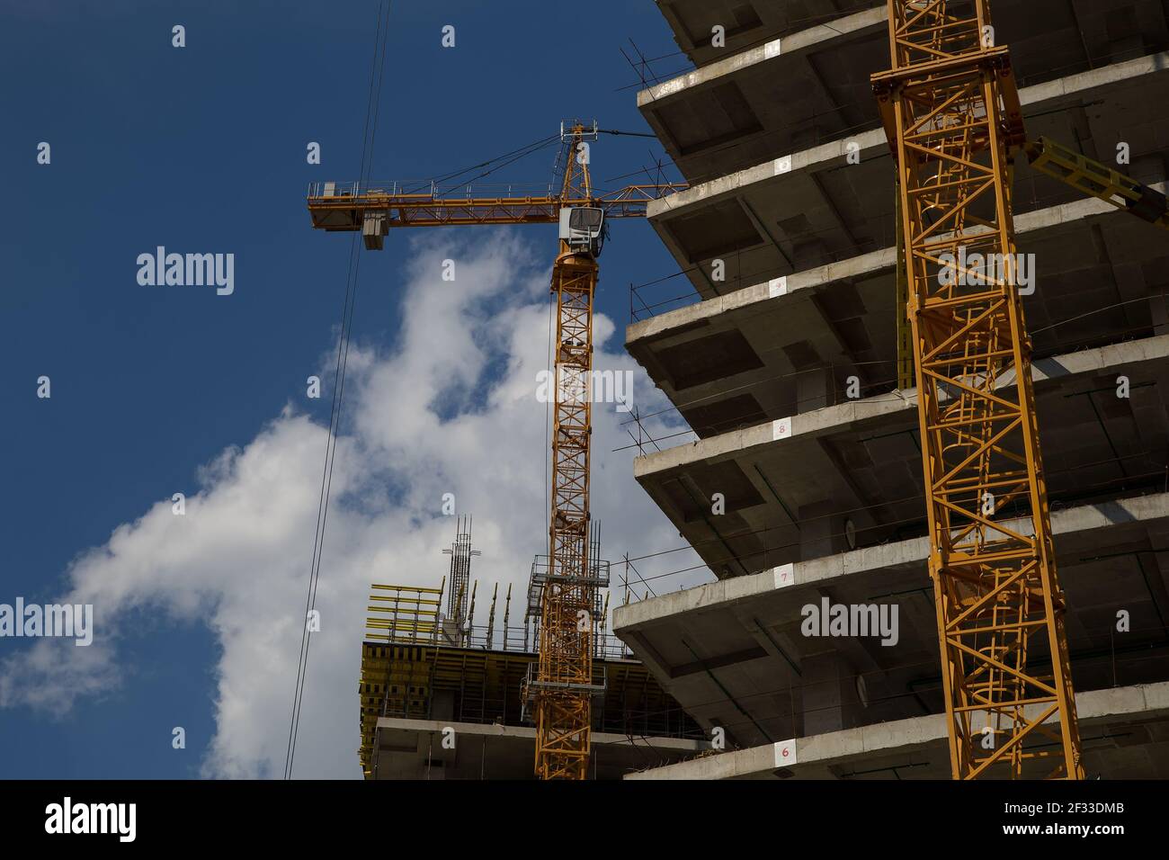 Cranes on a construction site. Industrial image Stock Photo - Alamy