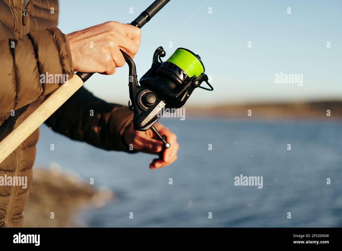 Fisherman hands holding fishing rod close up Stock Photo - Alamy