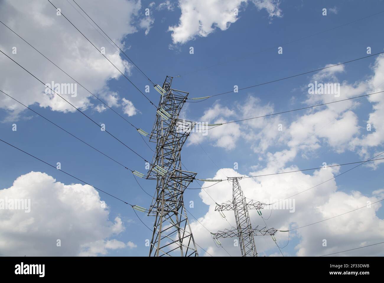 Electricity pylons and line against the blue sky and clouds Stock Photo ...