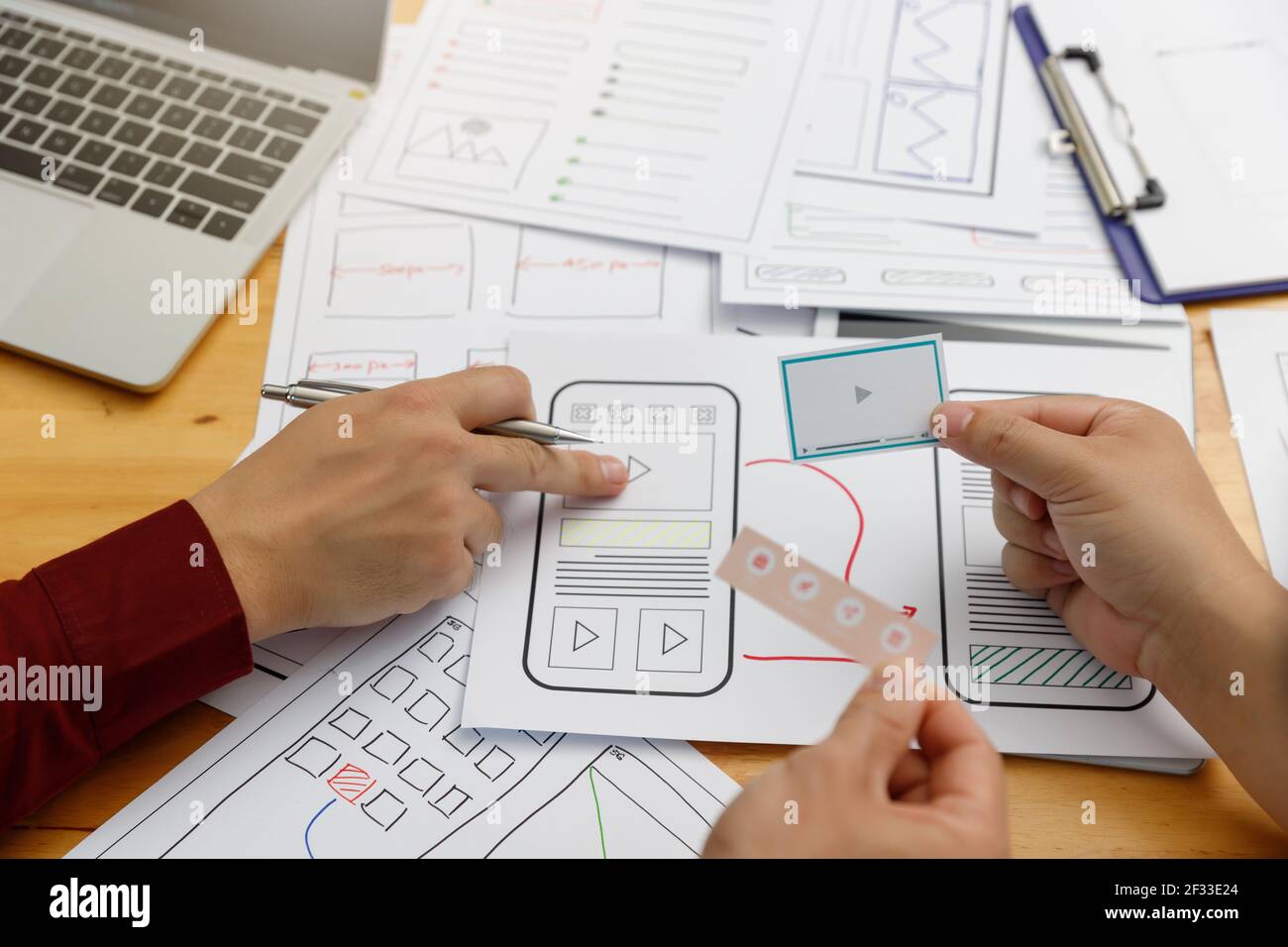 Graphic designers work together with UX UI designer planning ...