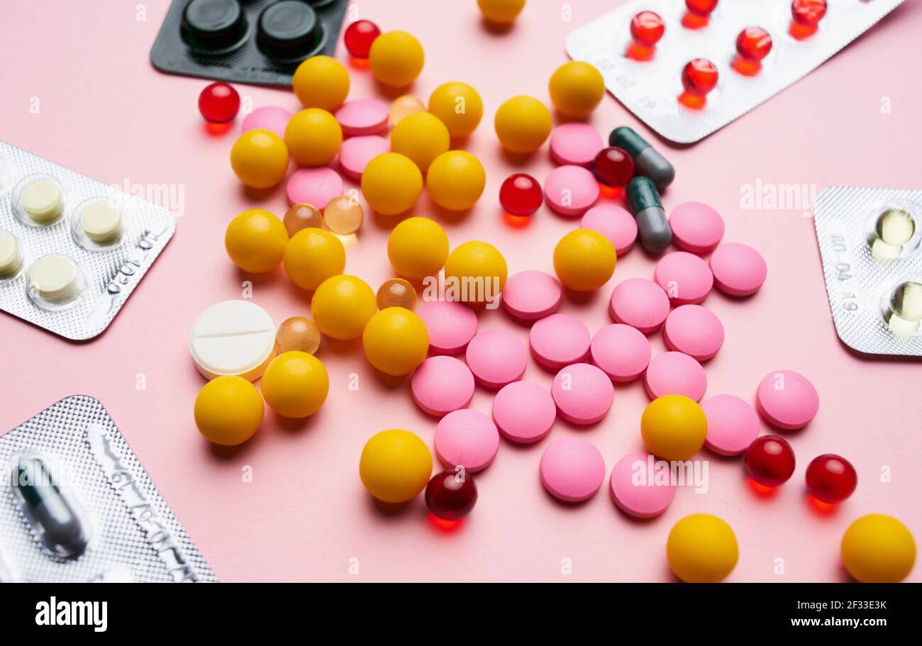 medicine pills vitamins first aid kit pink background Stock Photo - Alamy