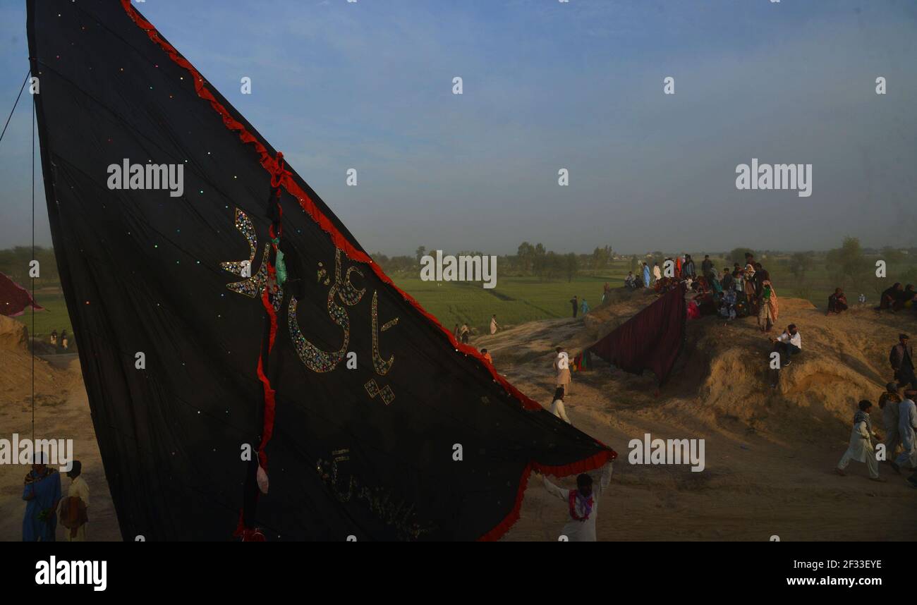 Pakistani devotees holding different colours of flags and travel ...