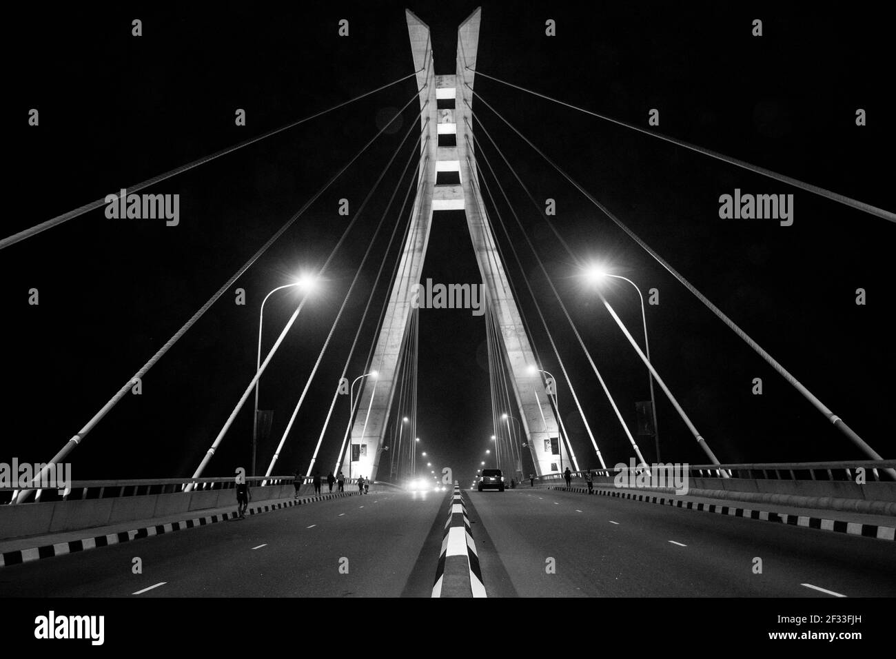 A black and white shot of the Lekki-Ikoyi Bridge in Lagos, Nigeria and ...