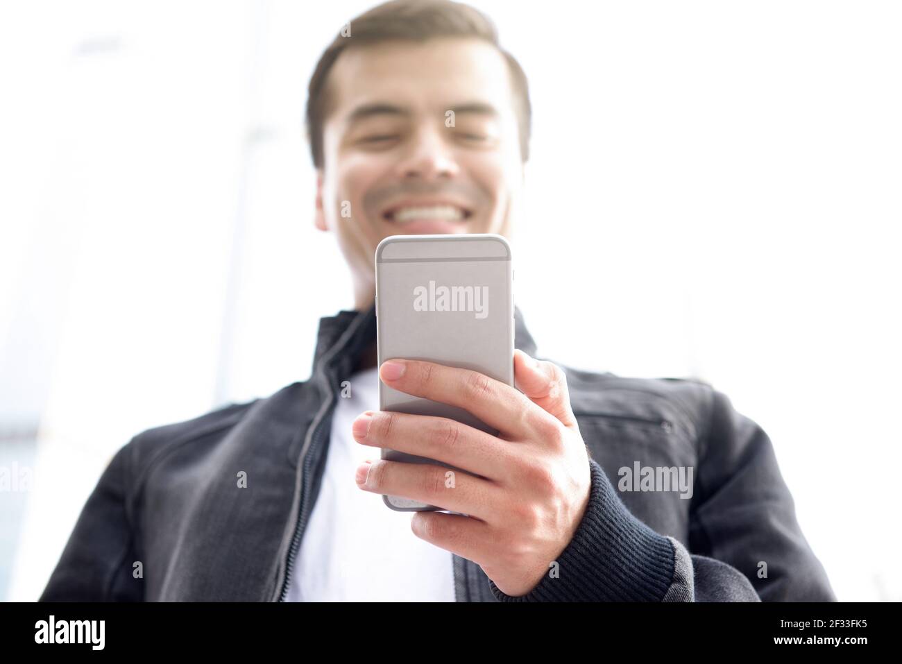 Handsome guy smiling using hi-res stock photography and images - Alamy