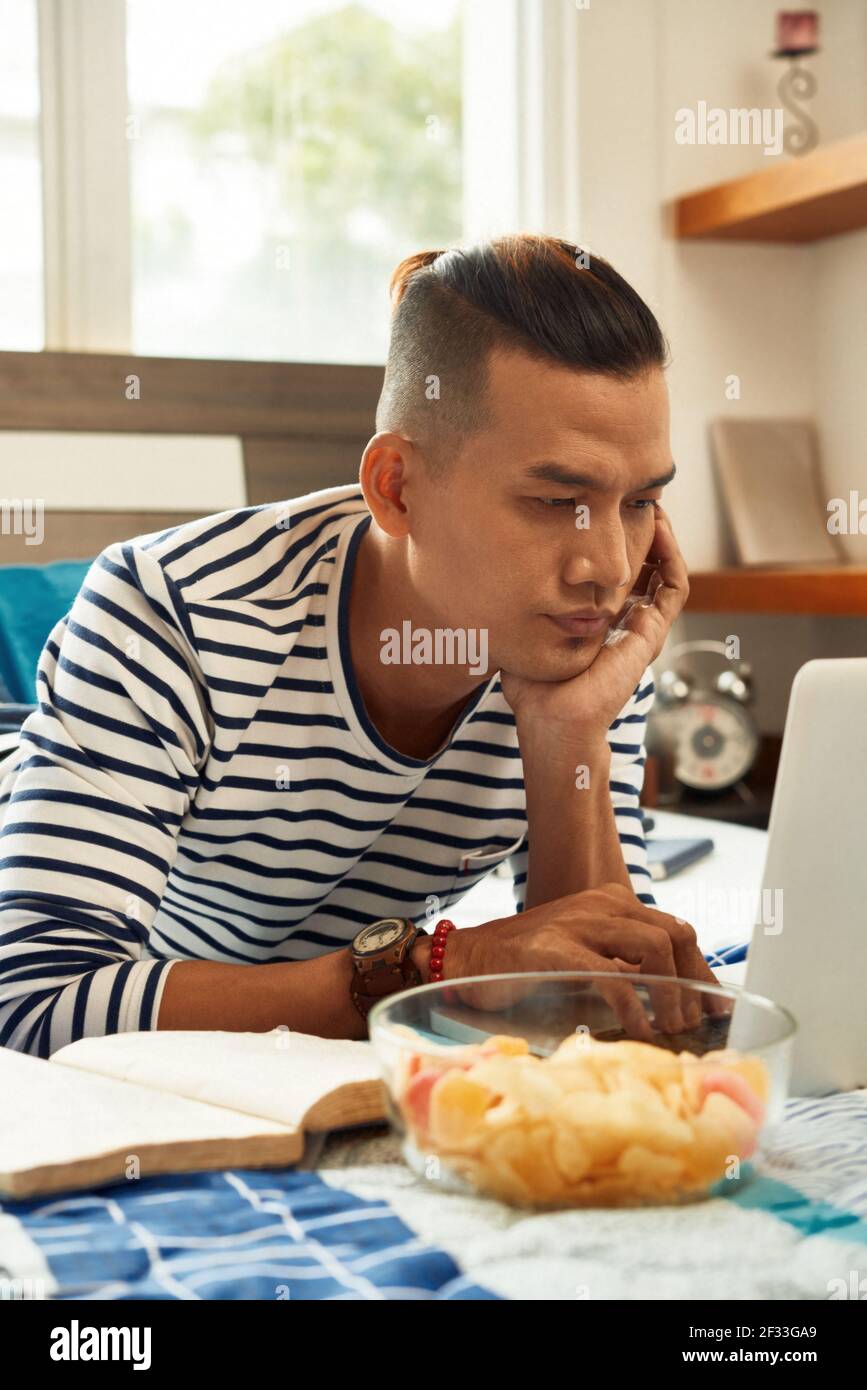 Young man eating potato chips hi-res stock photography and images - Alamy