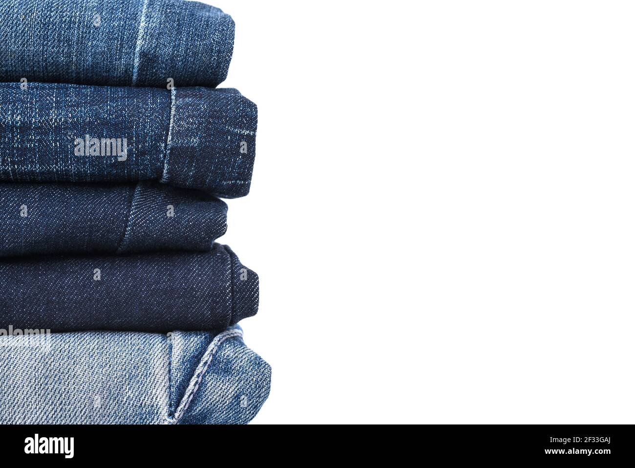 Stack of blue jeans on white background with copy space Stock Photo - Alamy