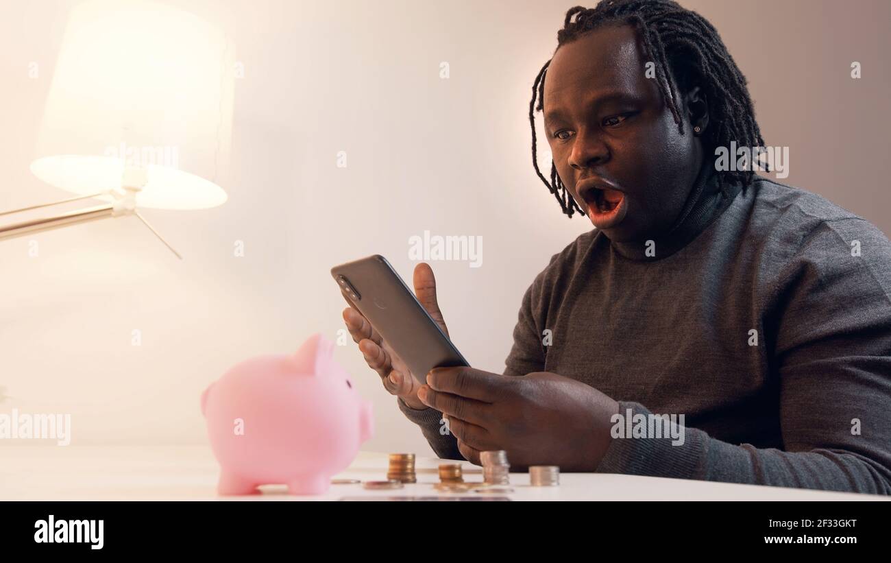 African american black man checking bank balance using mobile app ...