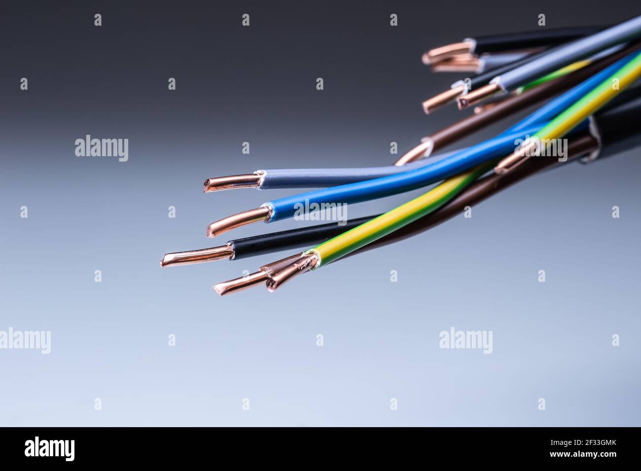 Colorful electrical cables with copper wiring ending on isolated grey ...
