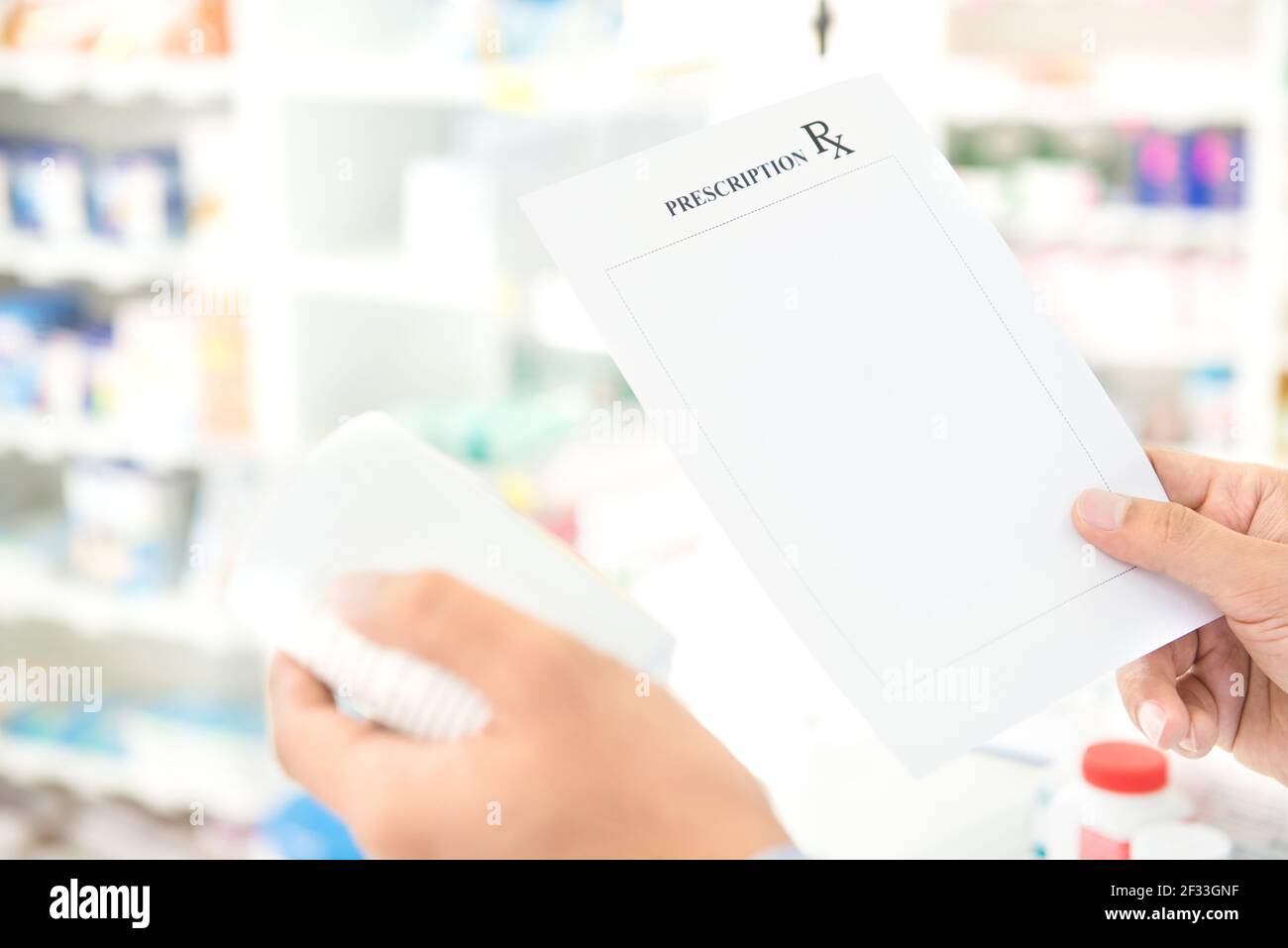 Pharmacist hand holding prescription checking medicine in drugstore ...