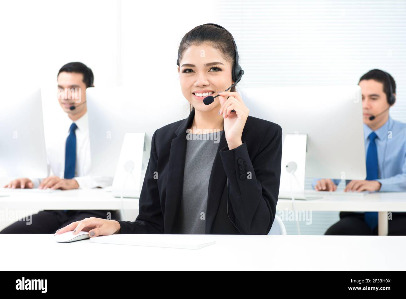 Young Asian woman as an operator working in call center Stock Photo - Alamy
