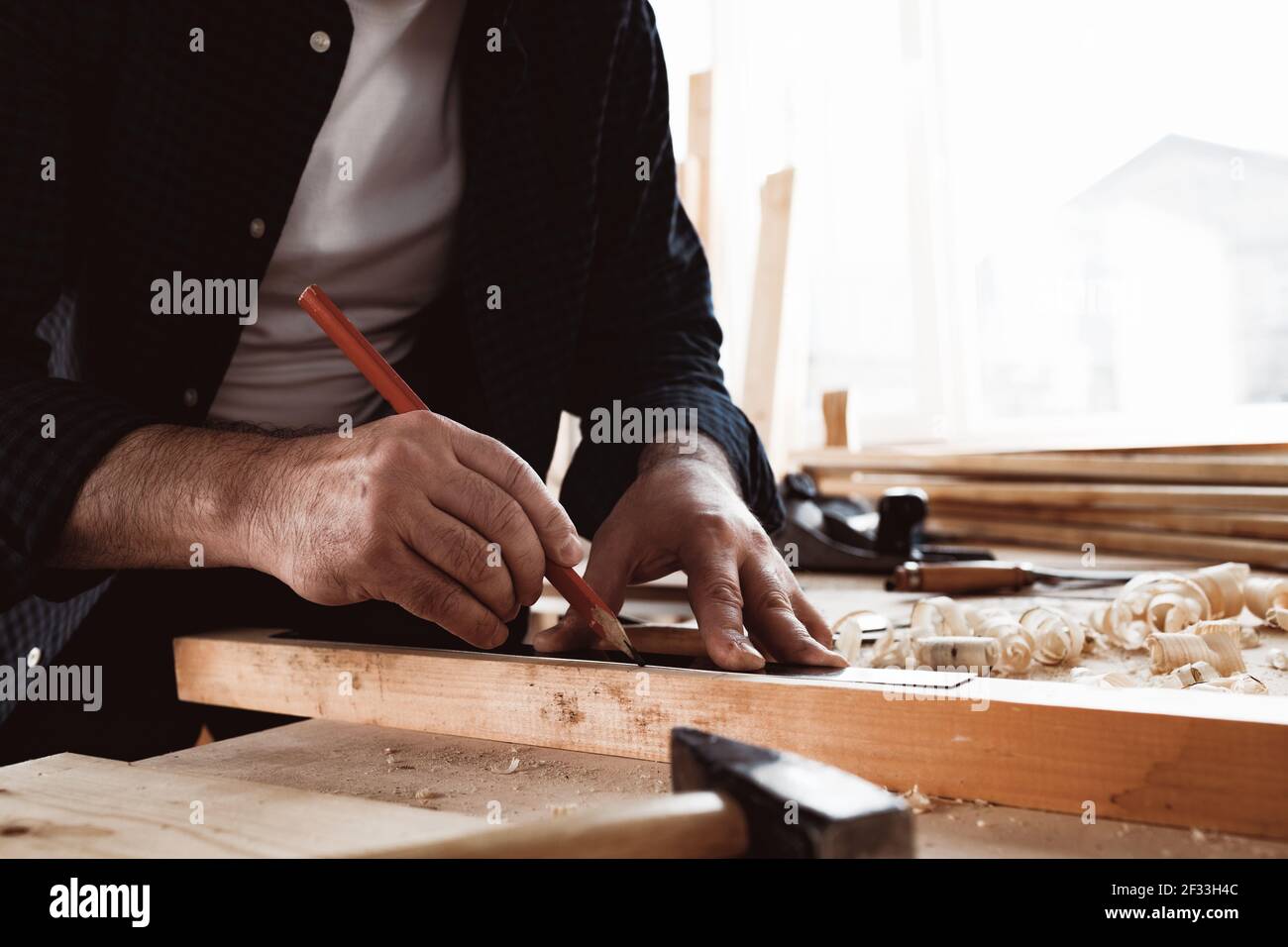 Carpenter makes pencil marks on a wood plank Stock Photo - Alamy