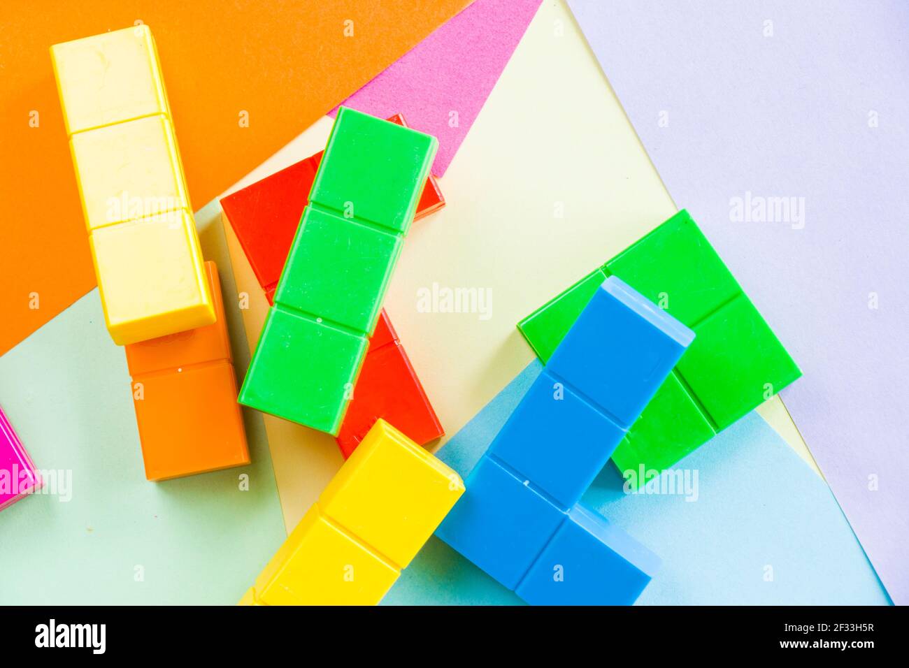 Colorful puzzle cubes background, geometric figures, table game ...