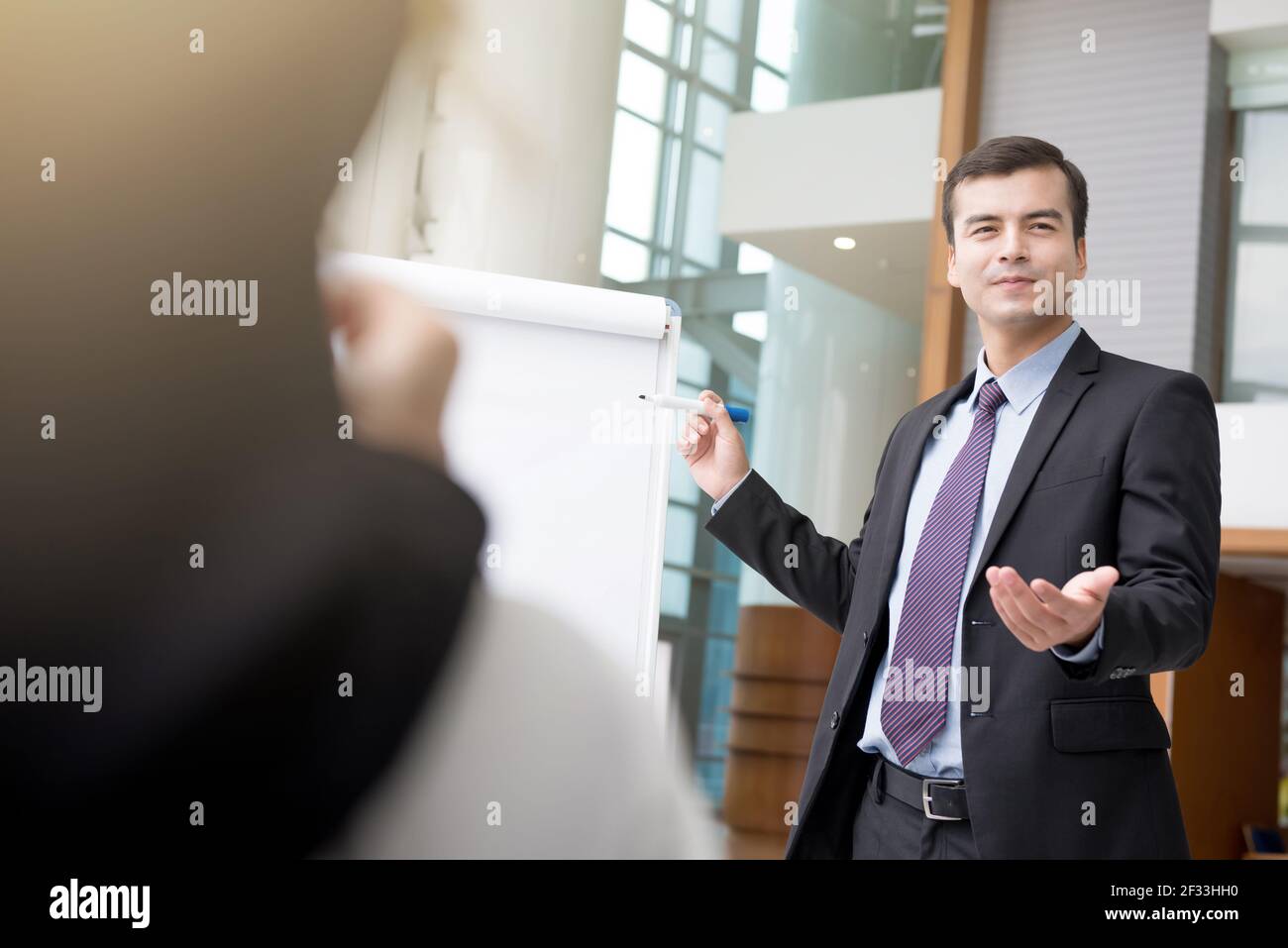 Young businessman as a meeting leader presenting his work Stock Photo ...