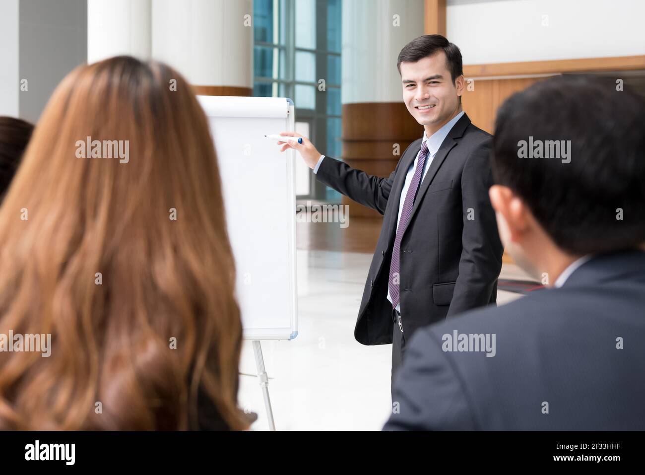 Young businessman as a meeting leader presenting his work Stock Photo ...
