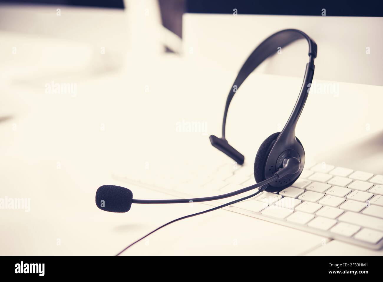 Microphone headset on computer keyboard in call center Stock Photo - Alamy