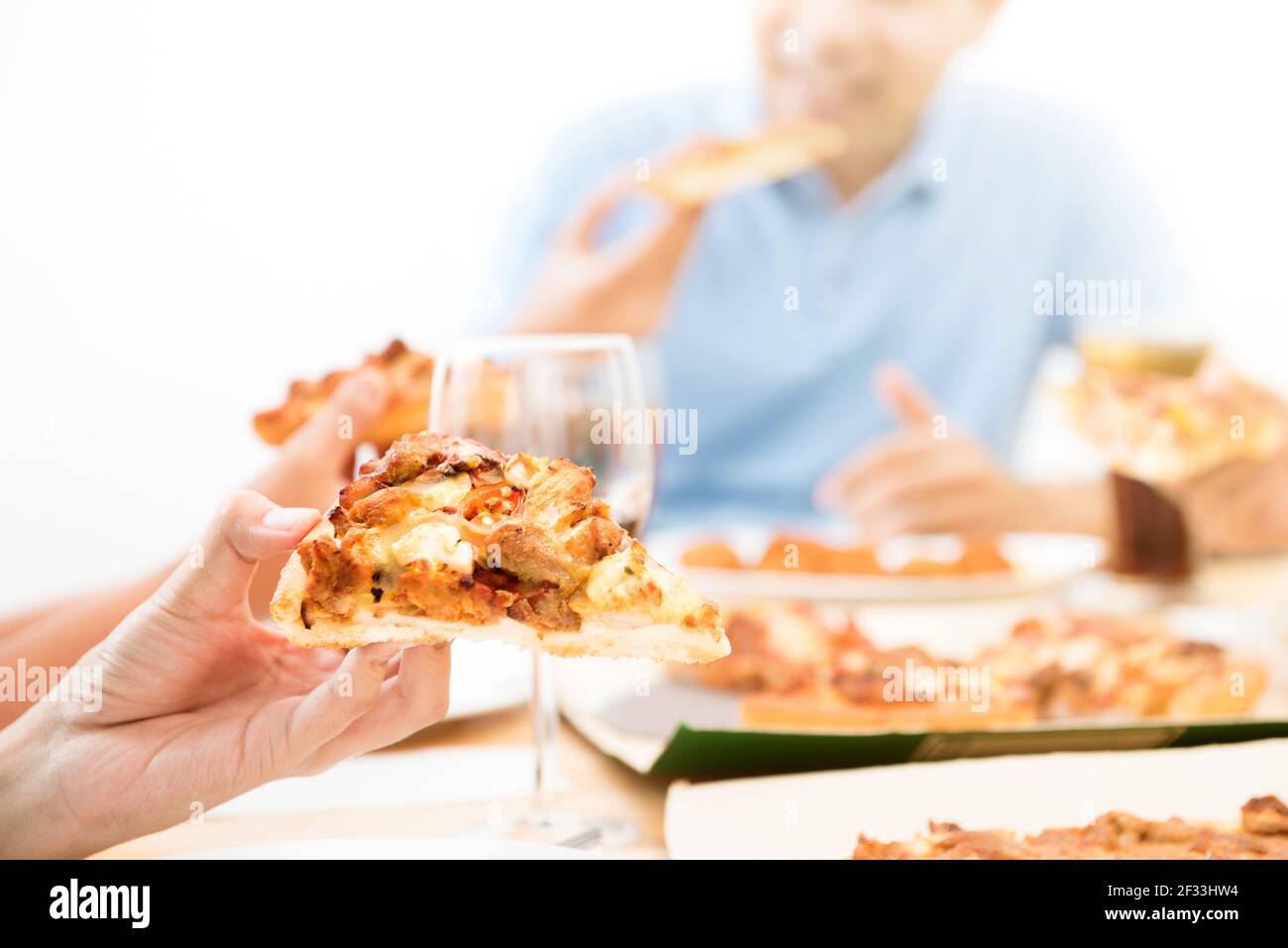 People eating pizza Stock Photo - Alamy