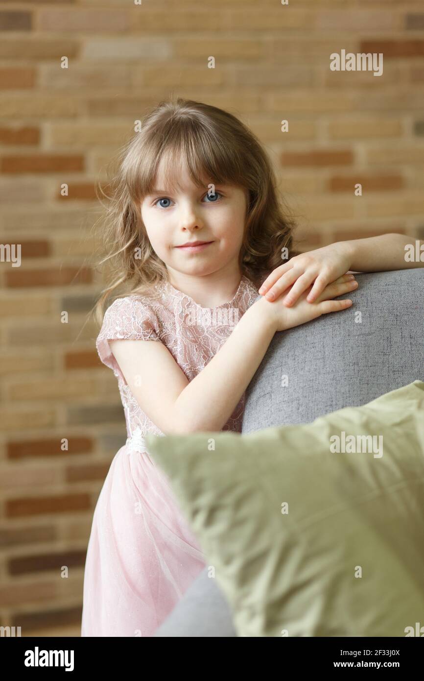 Adorable little girl looking at camera at home, smiling preschool ...