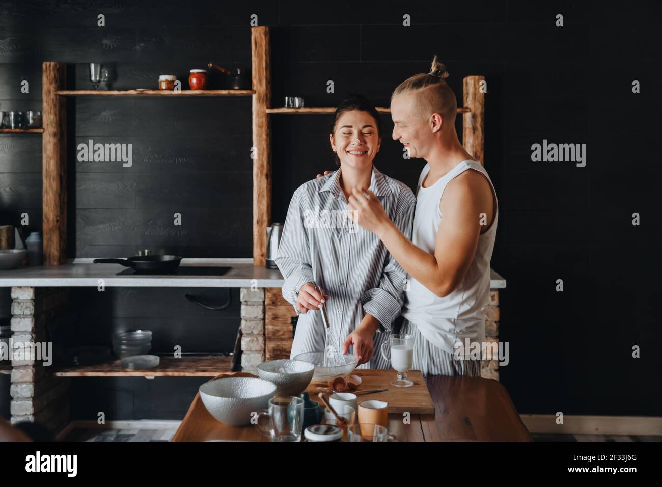 Young couple in love cook healthy food in the kitchen together. While ...