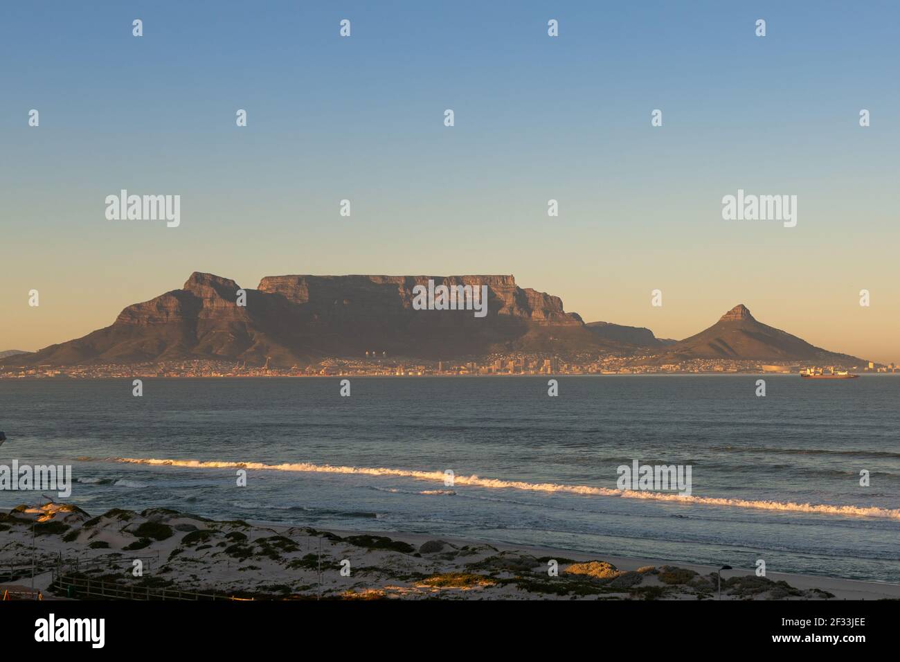 Table Mountain with blue and yellow sky during sunset seen from ...