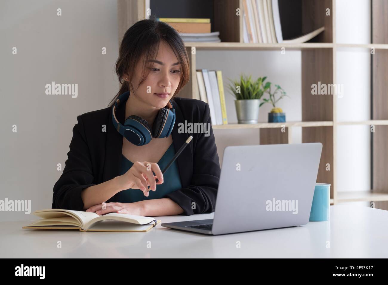 Young asian woman student e learning watching video training course sit ...
