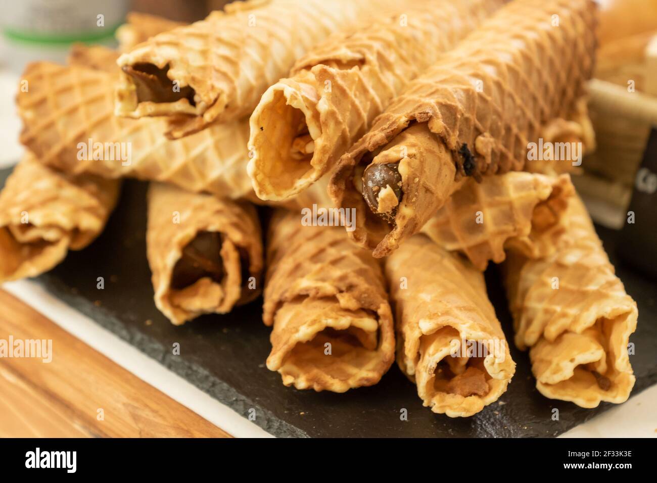 Homemade waffle rolls with condensed milk on buffet Stock Photo - Alamy