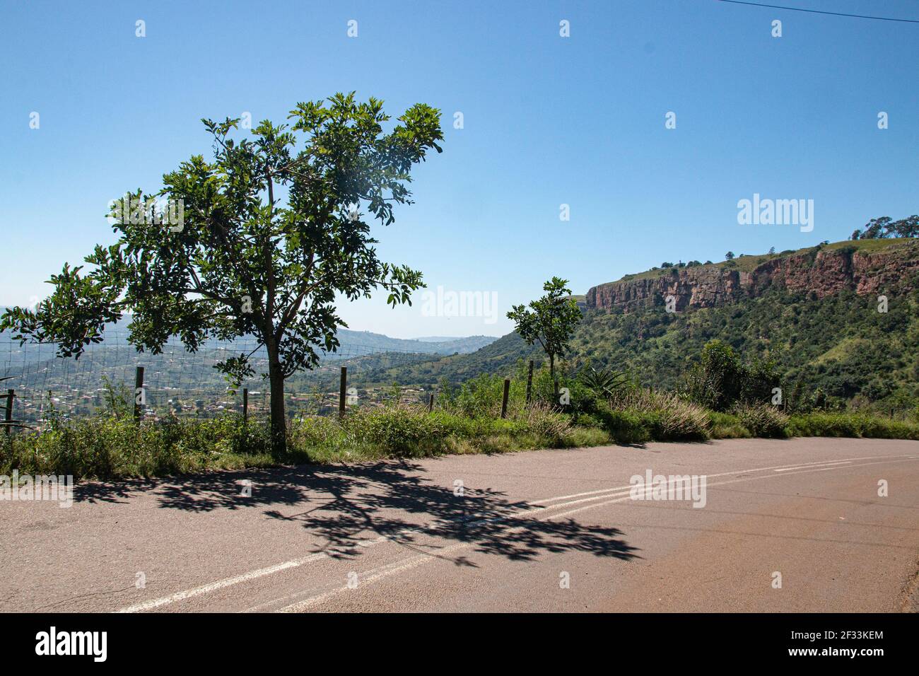 Winding asphalt road with steep cliff Stock Photo - Alamy