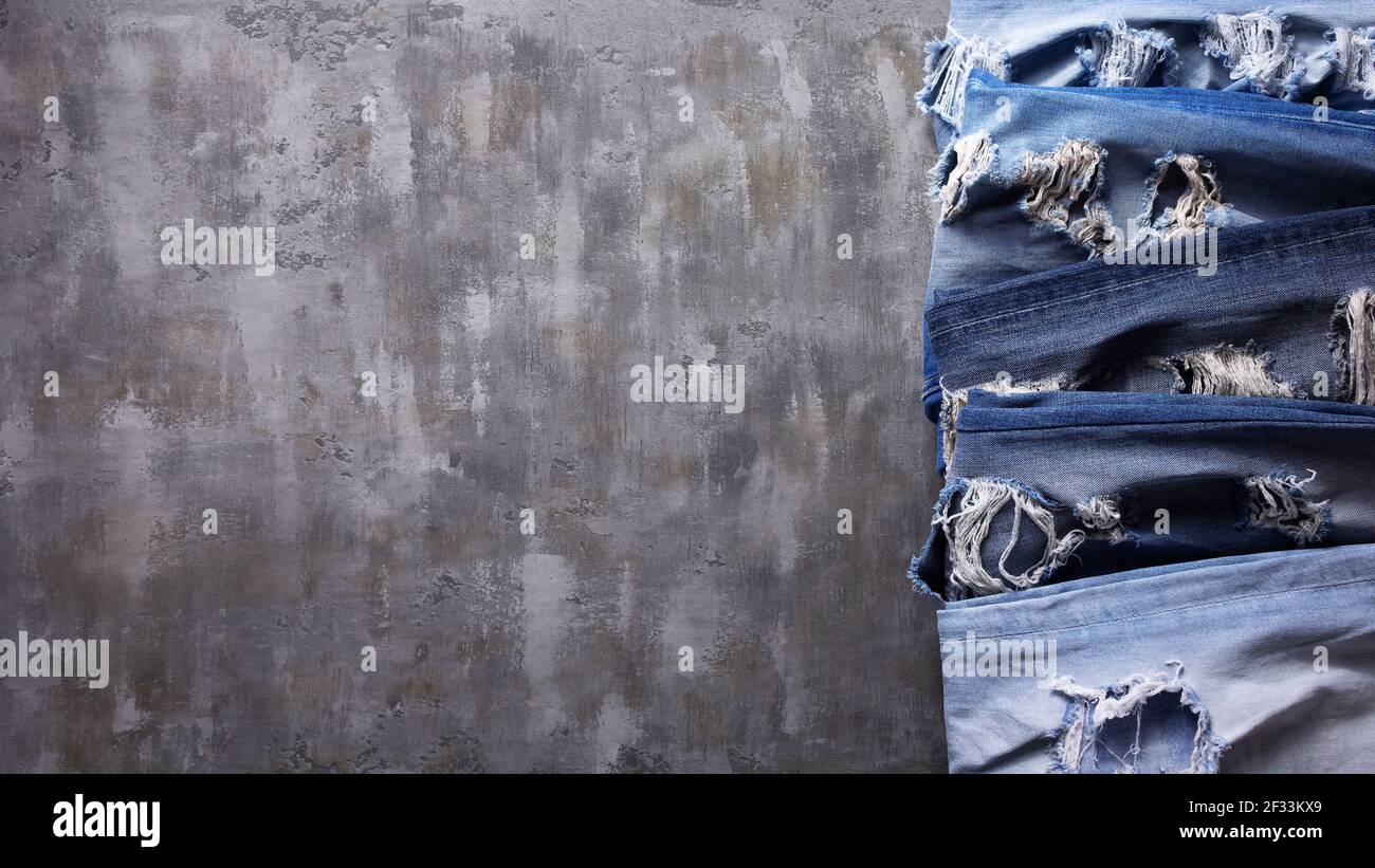 Denim jeans on old abstract background texture of table surface Stock ...