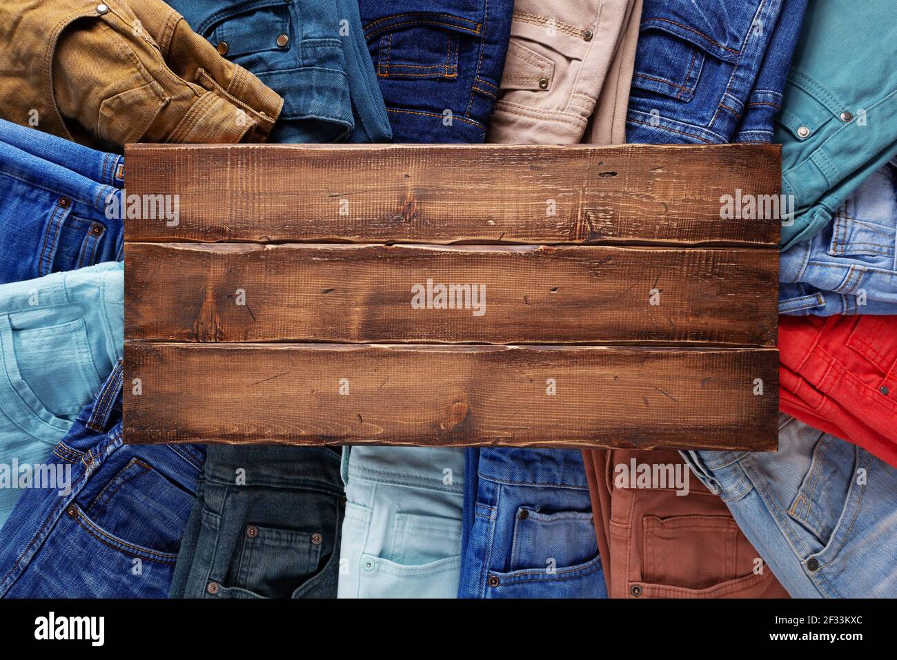Denim jeans on old wooden background texture table surface. Top view ...