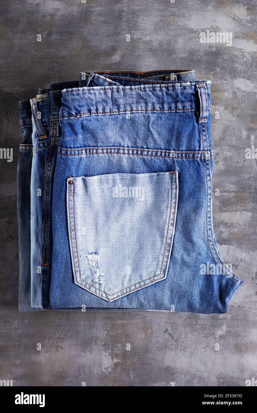 Denim jeans on old abstract background texture of table surface Stock ...