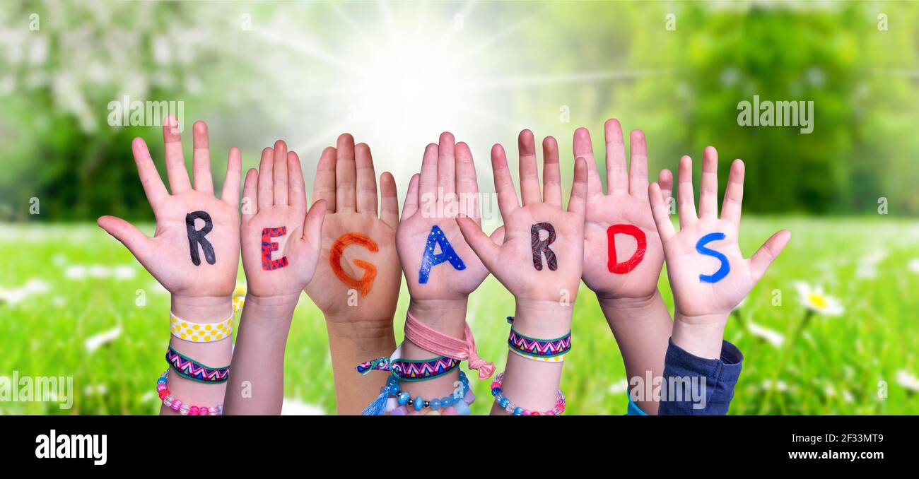 Children Hands Building Word Regards, Grass Meadow Stock Photo - Alamy