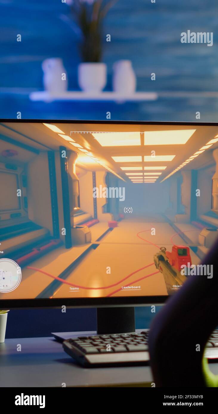 RGB powerful personal computer gamer rig with first-person shooter game ...