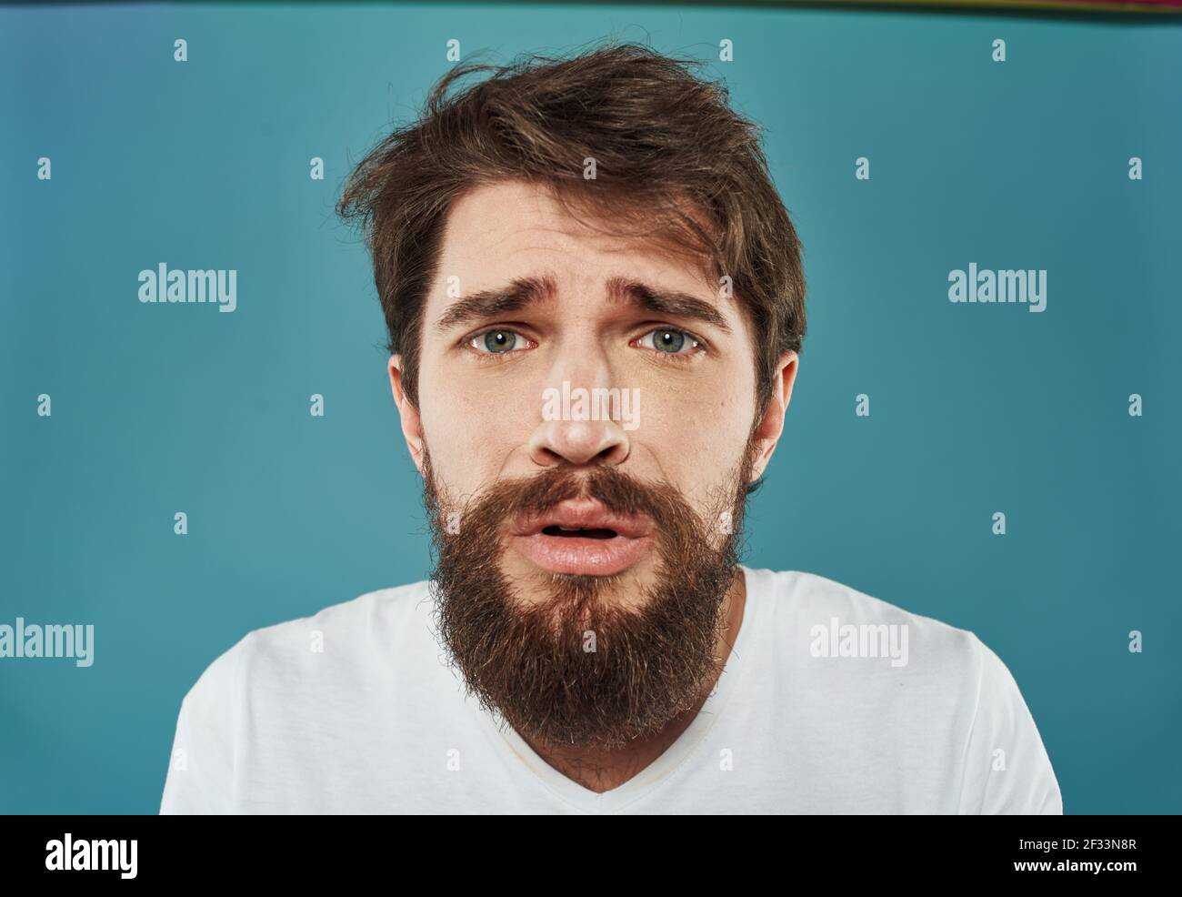 Upset man on blue background emotions model sadness cropped view Stock ...