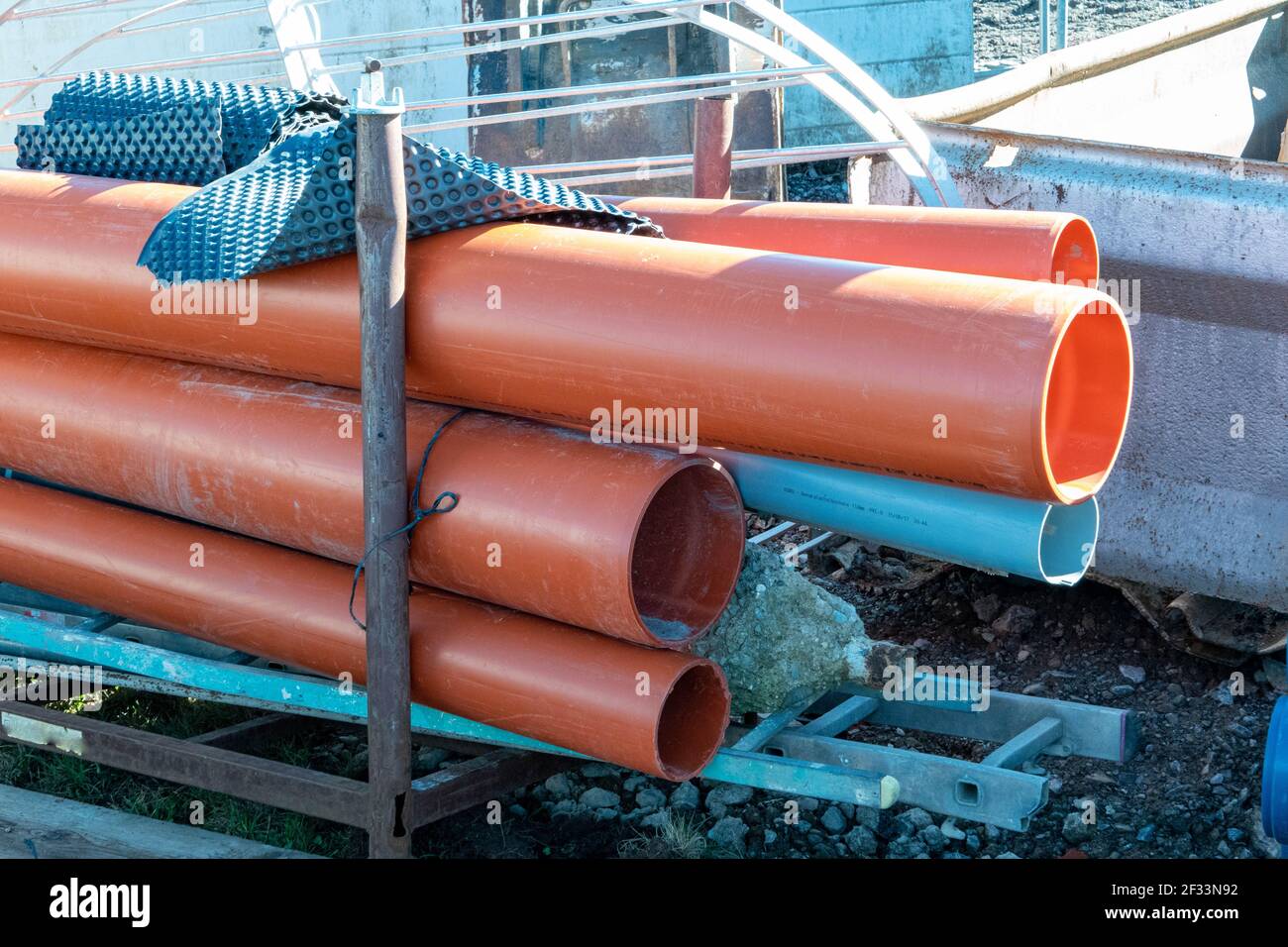 Orange plastic tubes stored at the construction site Stock Photo - Alamy