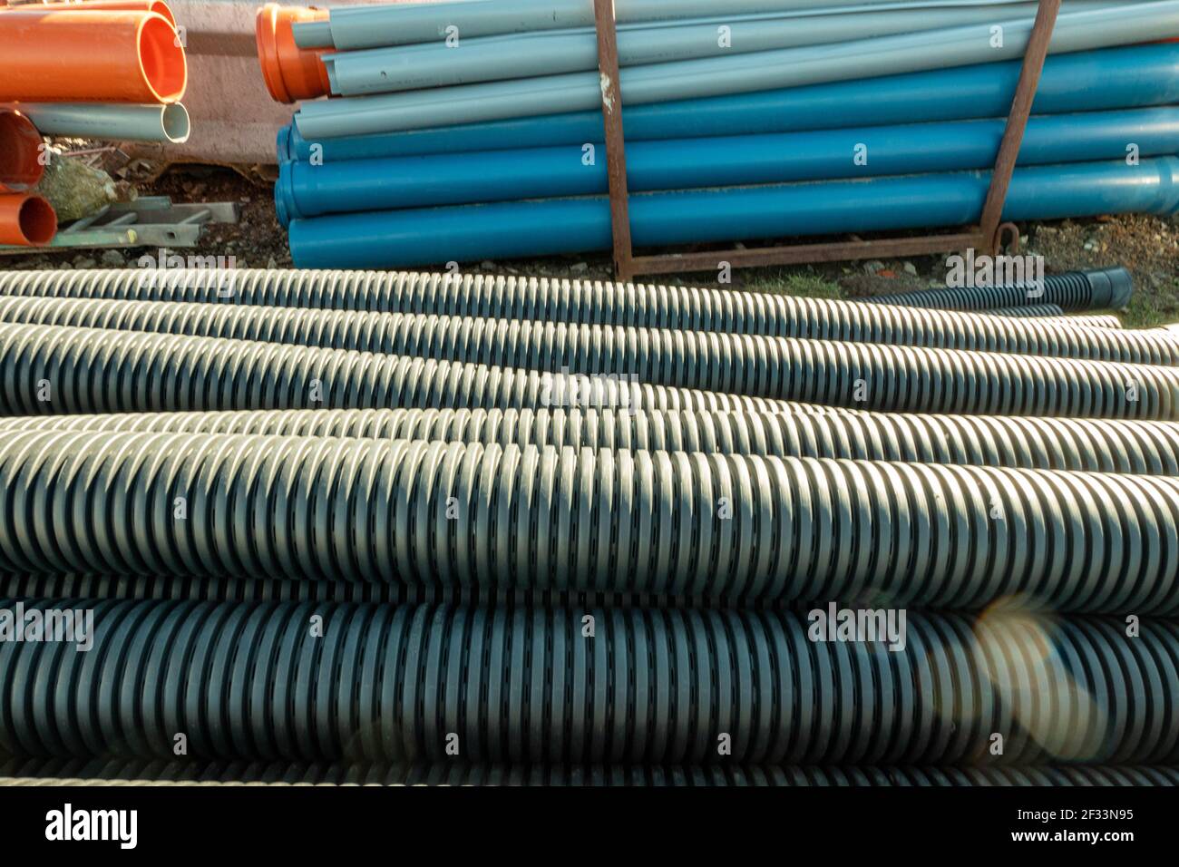 Plastic pipes with grooves on the construction site Stock Photo - Alamy