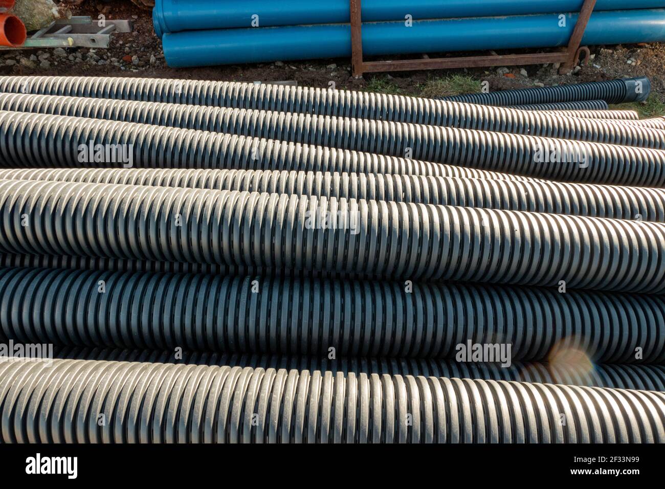 Plastic pipes with grooves on the construction site Stock Photo - Alamy