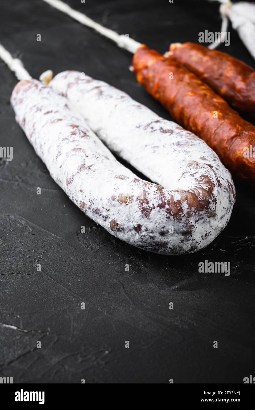 Traditional spanish sausages fuet and chorizo on black surface with ...