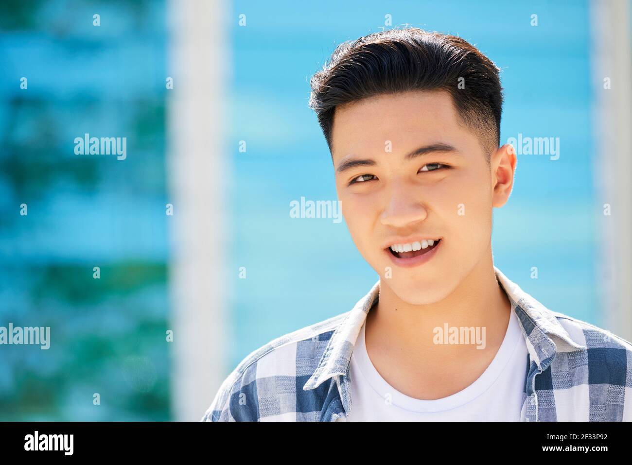 Portrait of handsome Asian young man smiling at camera Stock Photo - Alamy