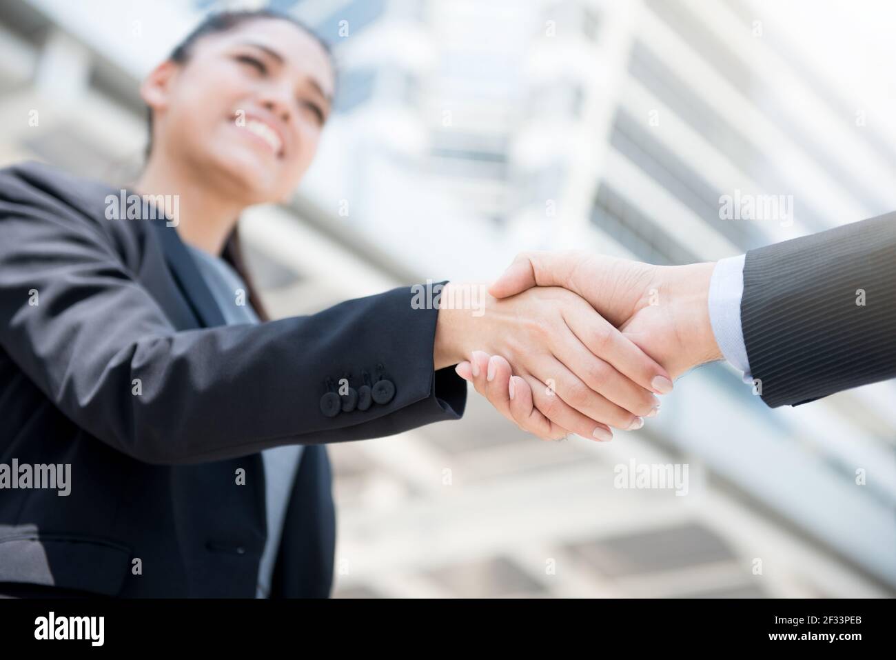 Business woman leader making handshake with her partner - greeting and ...
