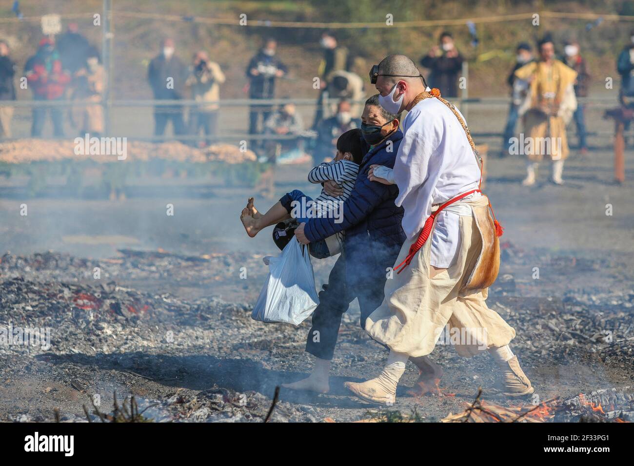 Hachioji, Japan. 14th Mar, 2021. A monk helps a child and his ...