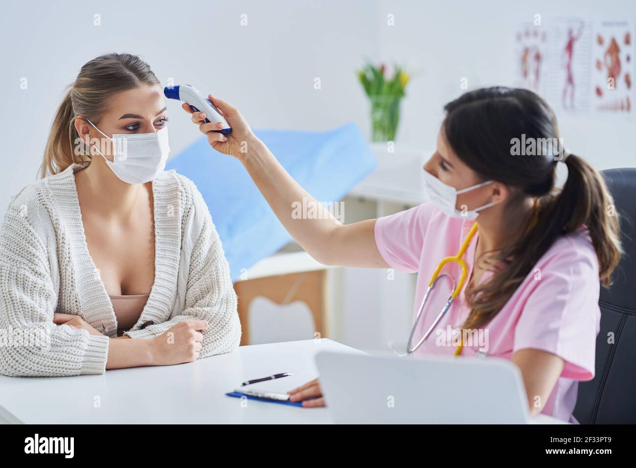 Doctor measuring temperature patient in hi-res stock photography and images - Alamy