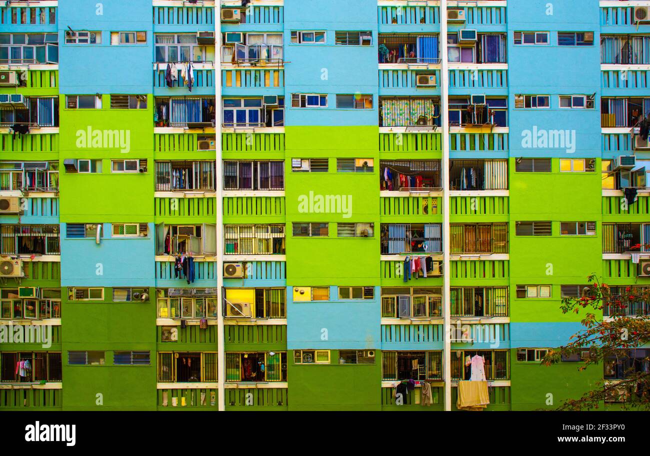 Newly painted green and blue tenement flats in Hong Kong. Washing can ...