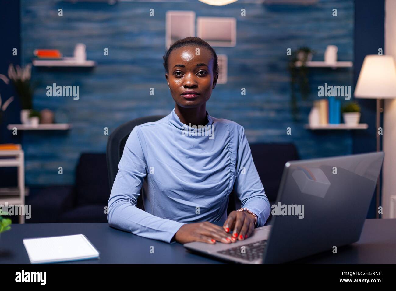African business woman looking seriously at camera in the course of ...