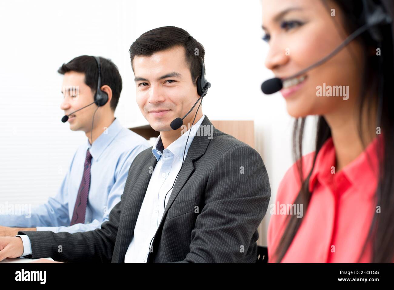 Call center workers wearing microphone headsets - telemarketing ...