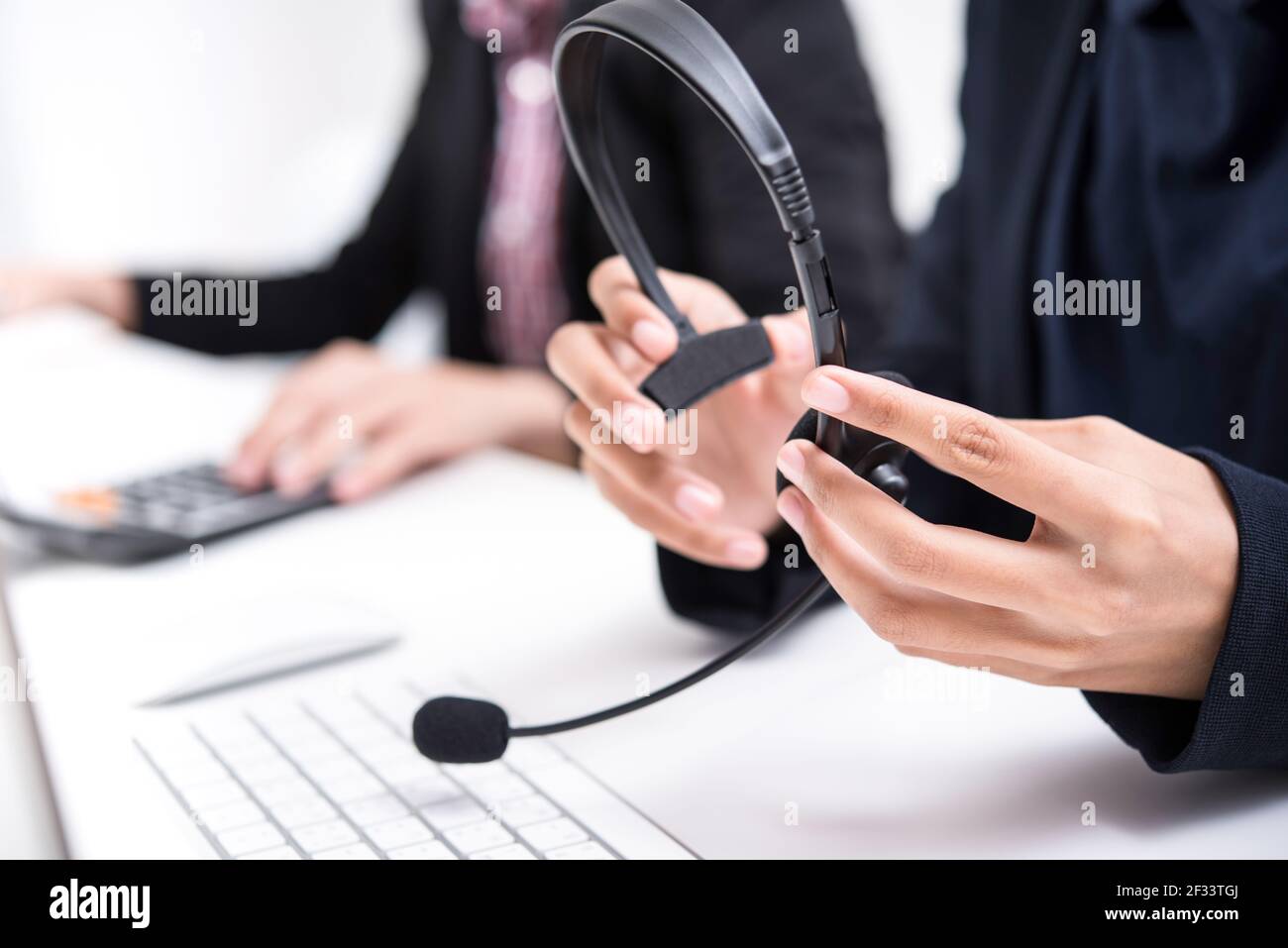 Woman hands holding microphone headset about to wear - call center ...