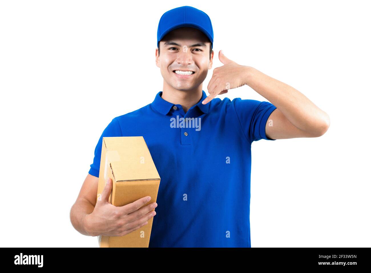 Smiling handsome delivery man holding box and making call me gesture ...